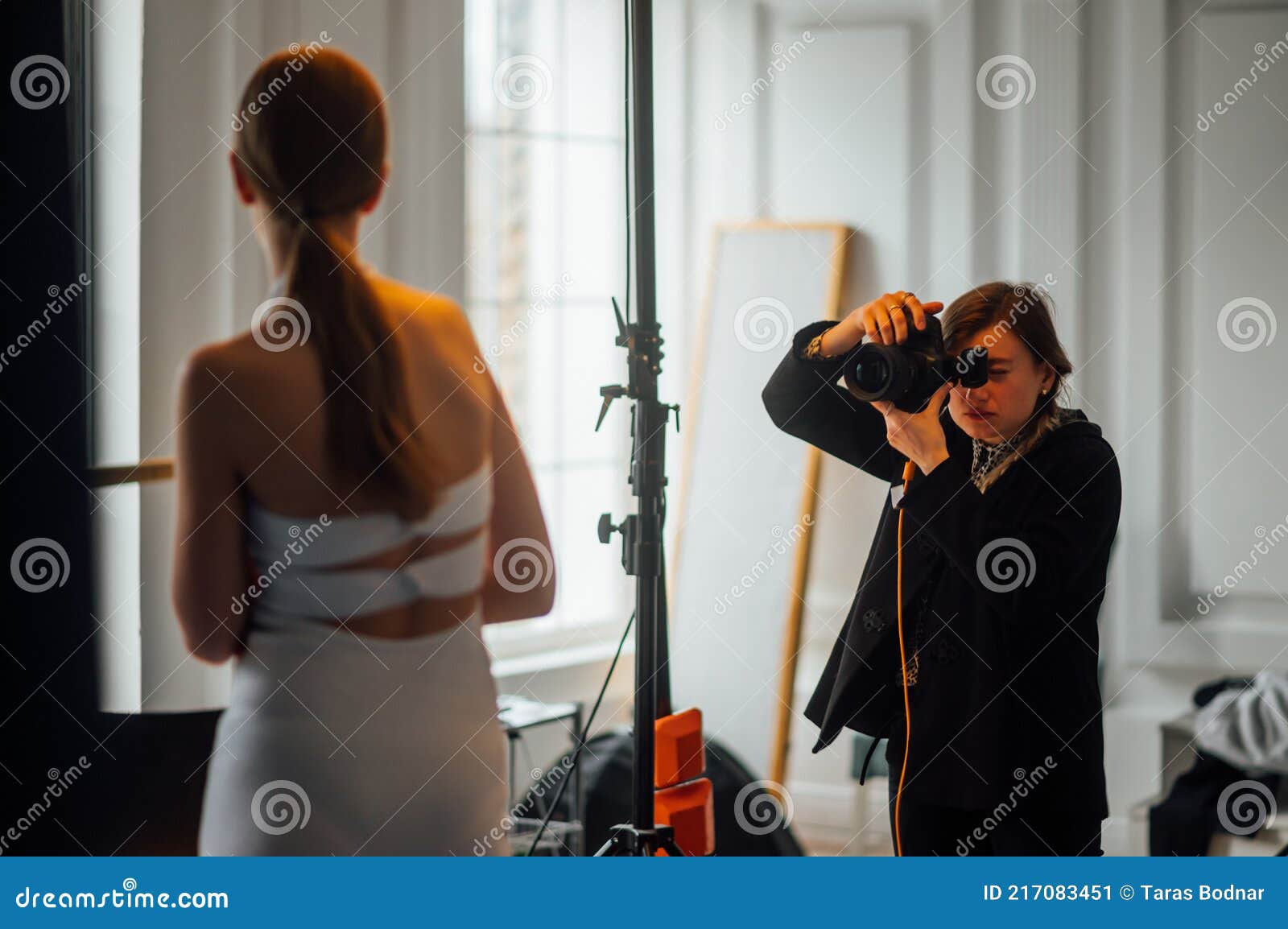 Woman Professional Photographer Working in the Studio with a Model ...
