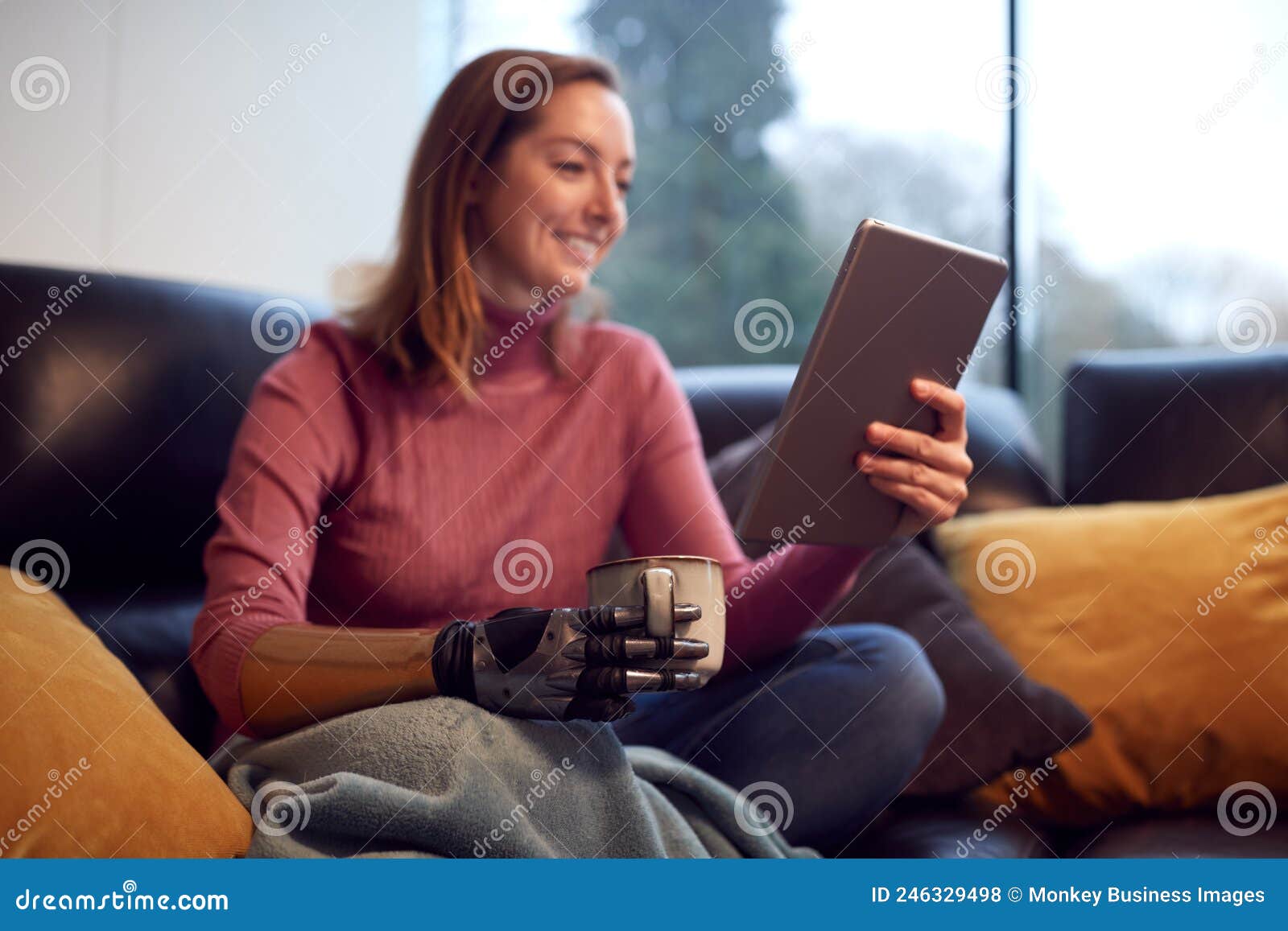 Woman with Prosthetic Arm and Hand at Home Using Digital Tablet ...