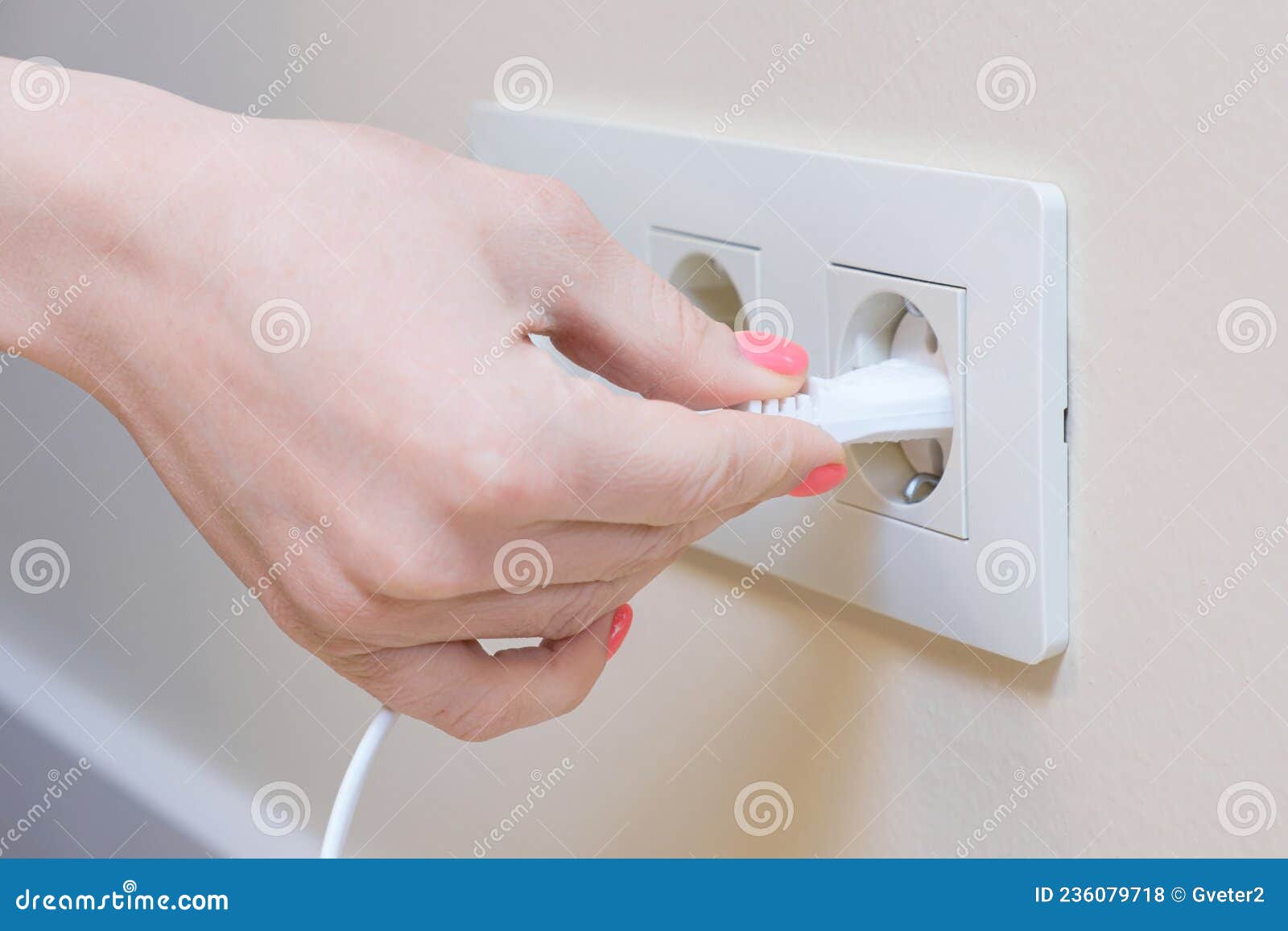 The Woman Pulls the Electrical Plug Out of the Socket Wire Stock Photo ...