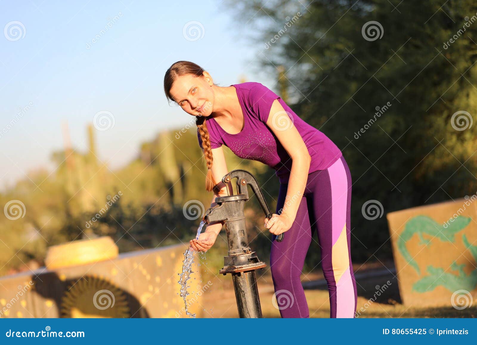 Woman Pumping a Well stock image. Image of outdoor, handle - 80655425