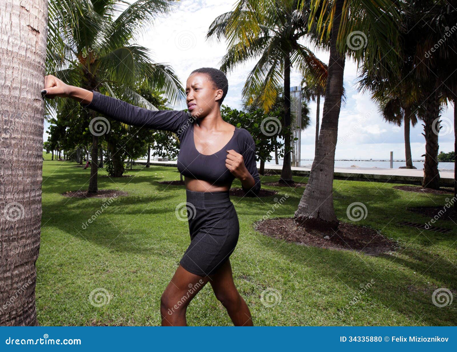 Woman punching a tree stock photo. Image of fighting - 34335880