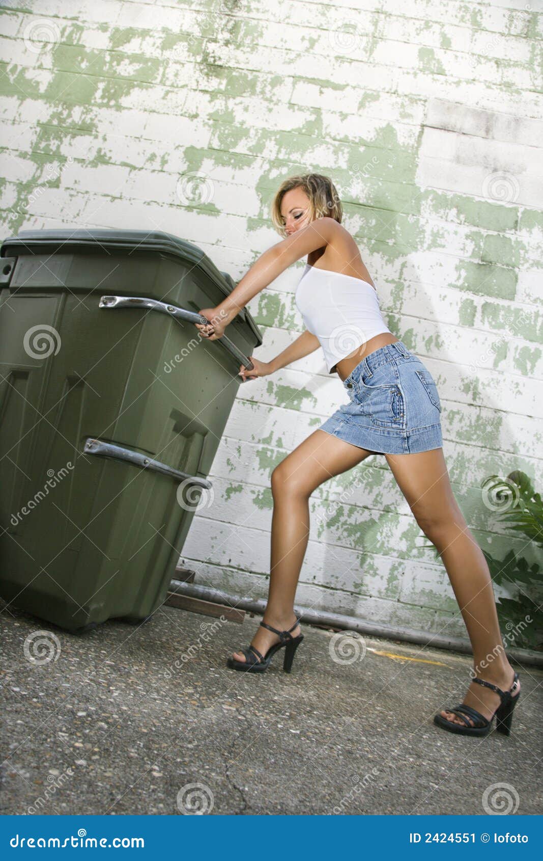 Woman pushing trash can. stock image. Image of length - 2424551