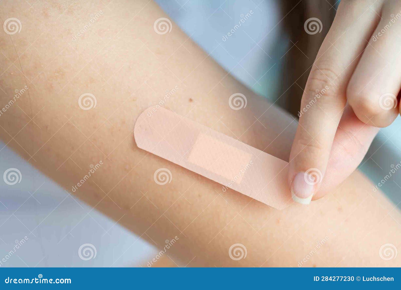 Woman putting a band-aid stock photo. Image of caucasian - 284277230