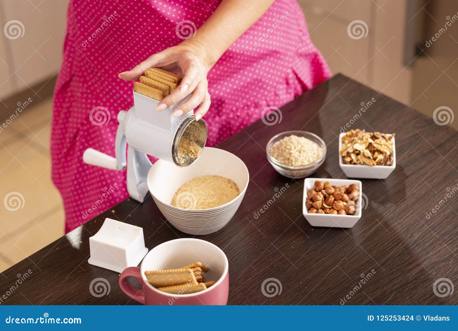Woman Putting Biscuits in a Grinding Machine Stock Photo - Image of ...