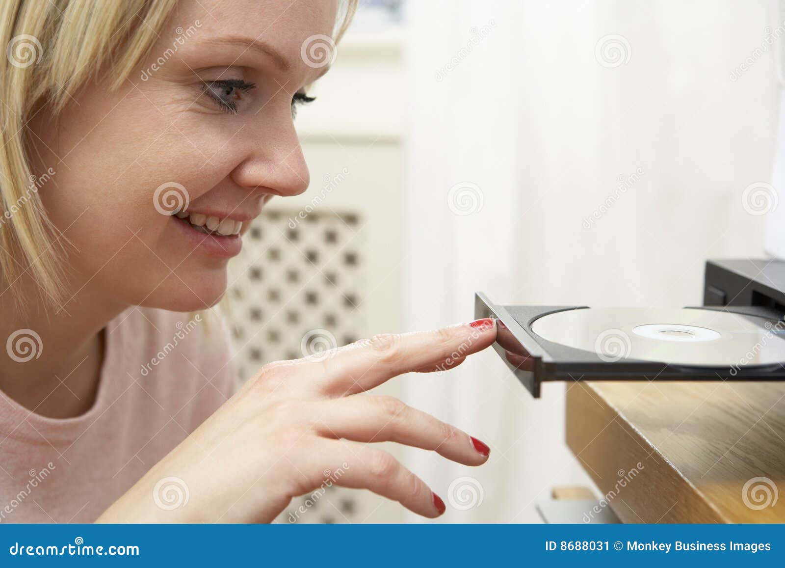 Woman Putting Disc in DVD stock image. Image of color - 8688031