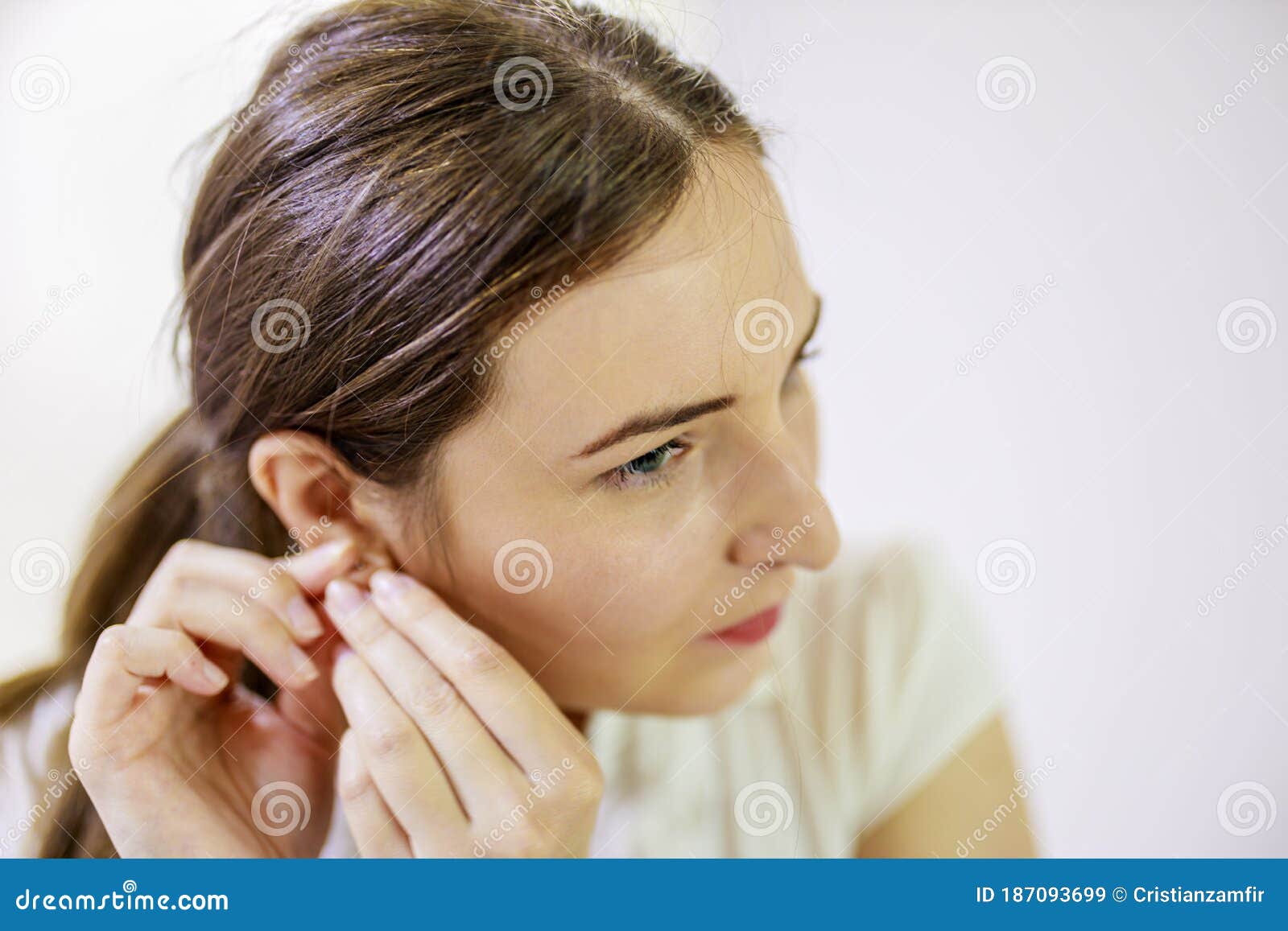 Woman Putting in Earrings on Her Ears Stock Image - Image of young ...