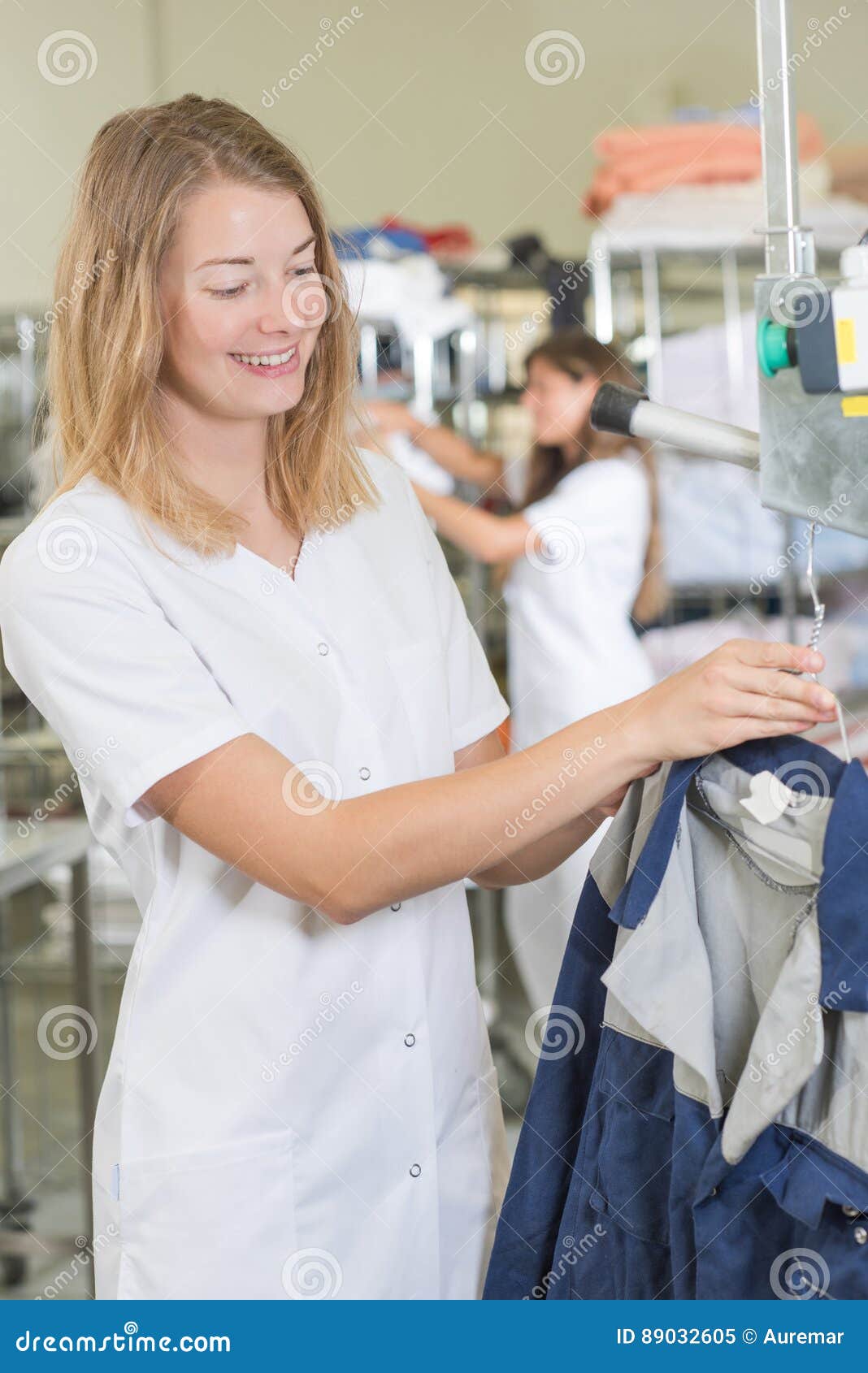 Woman Putting Jacket on Hanger Stock Image - Image of industry, uniform ...