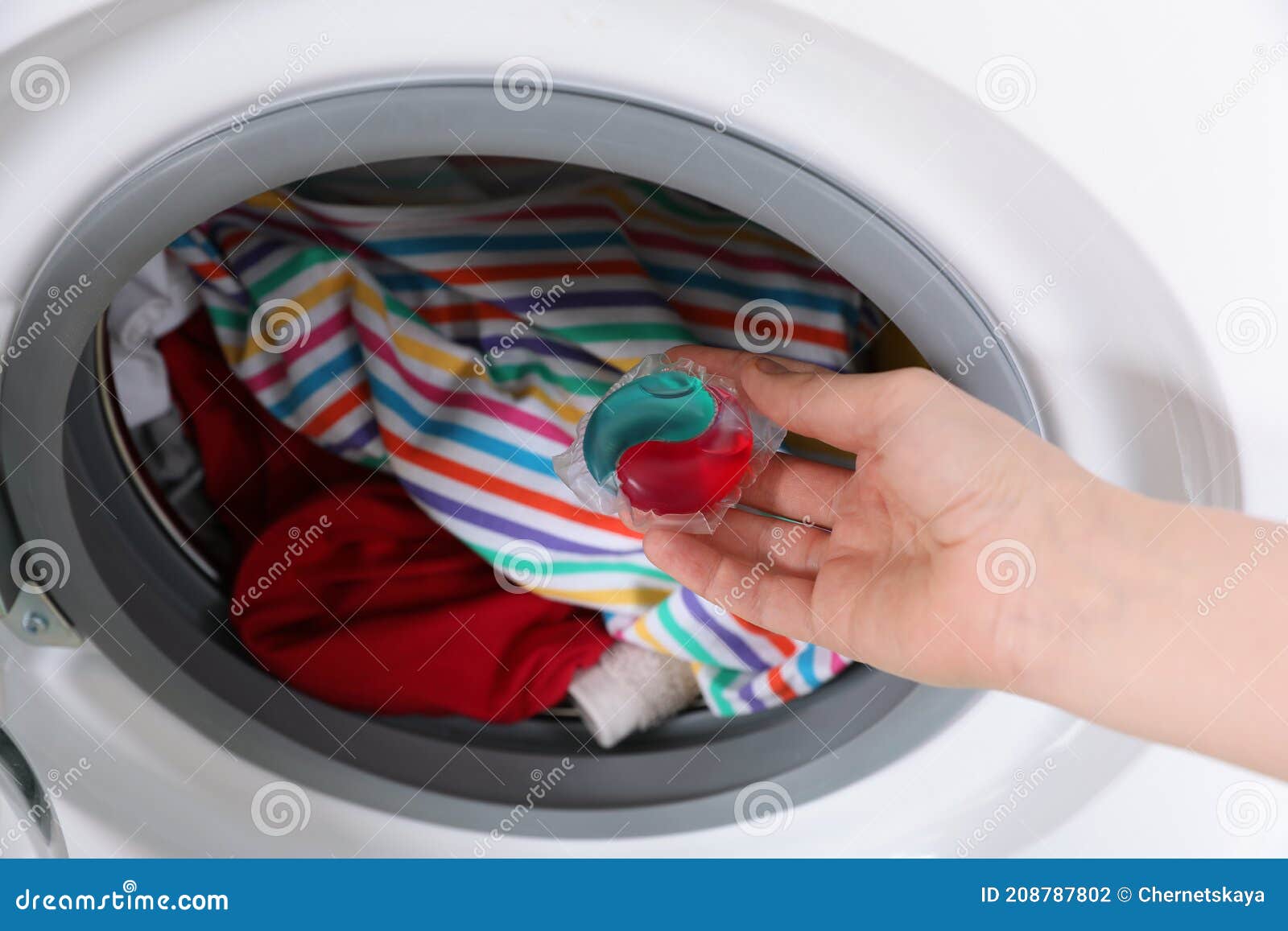 Woman Putting Laundry Detergent Capsule into Washing Machine, Closeup ...