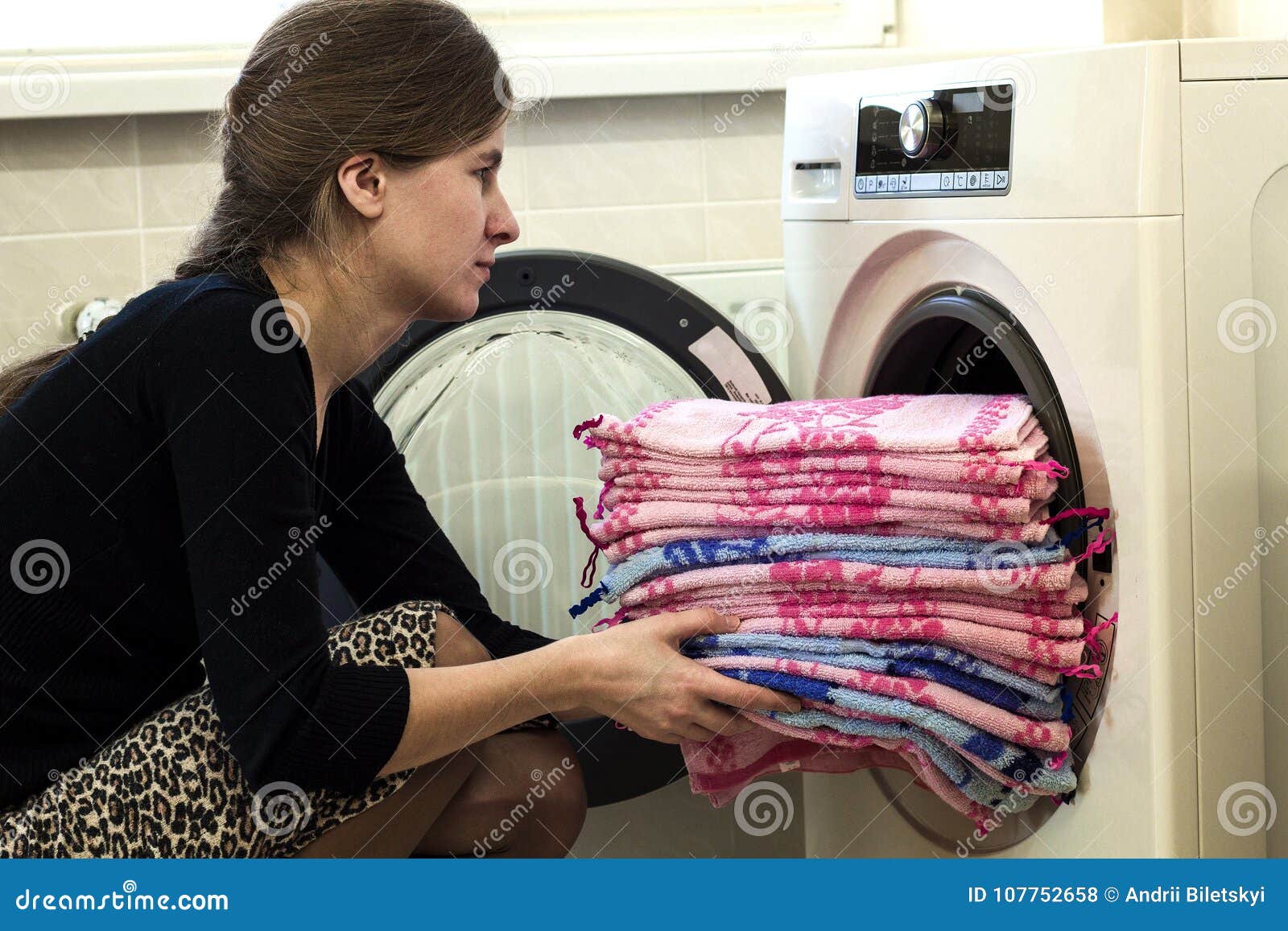 Woman Putting Laundry into Washing Machine at Home Stock Photo - Image ...