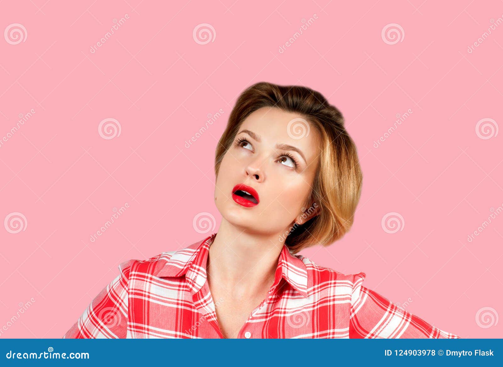 Woman with Questioning Expression Looking Up on Pink Background Stock ...
