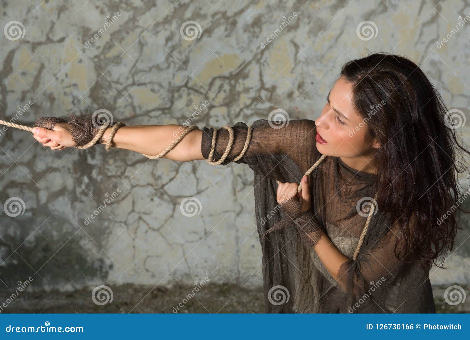 Woman pulling a rope stock photo. Image of strength - 126730166