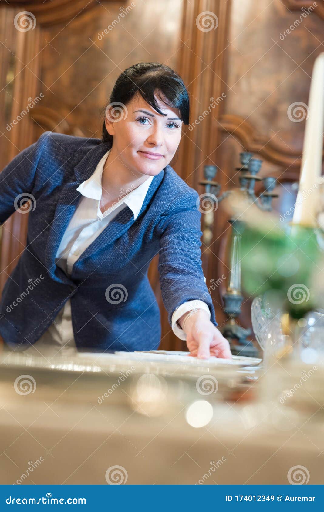 Woman Reaching for Plate on Table Antiques Stock Image - Image of ...
