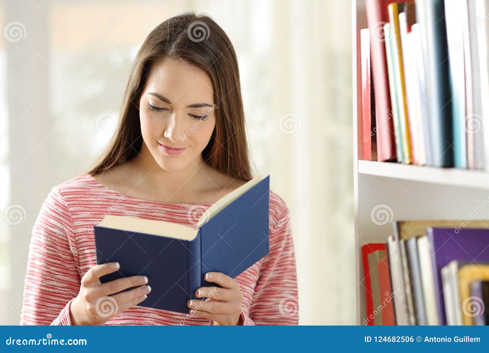 Woman Reading a Book Standing at Home Stock Photo - Image of library ...