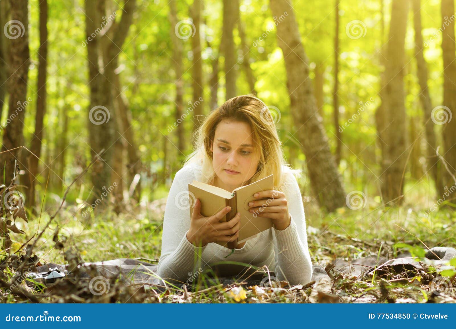 Woman reading in forest stock photo. Image of female - 77534850