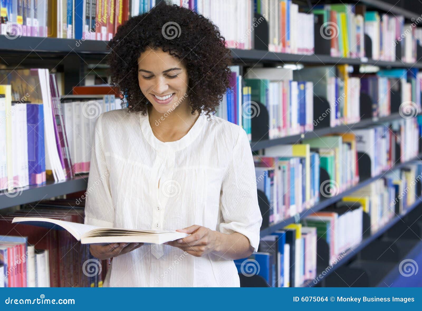 Woman reading in a library stock photo. Image of woman - 6075064
