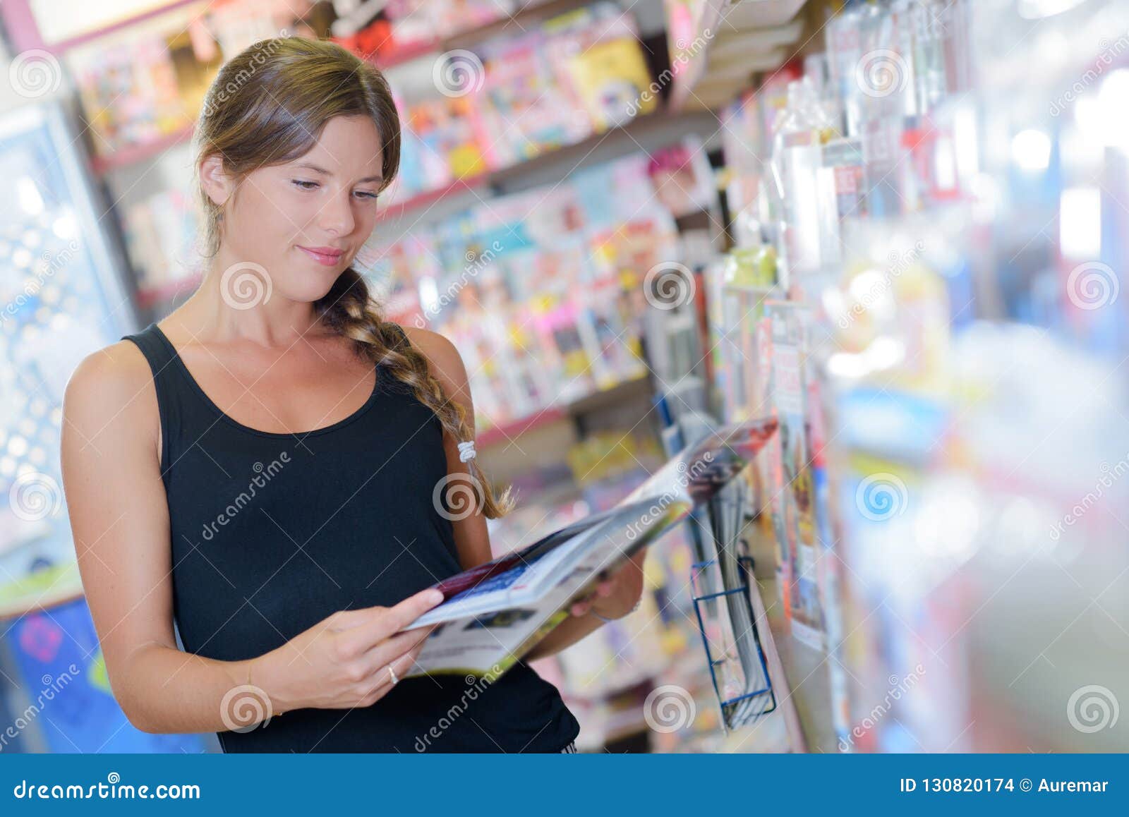 Woman reading a magazine stock photo. Image of print - 130820174
