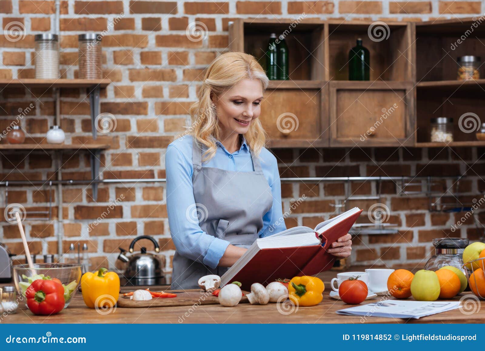Woman reading recipe book stock photo. Image of eating - 119814852