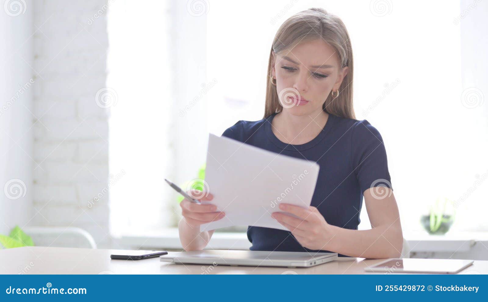 Woman Reading Reports while Sitting in Office Stock Photo - Image of ...