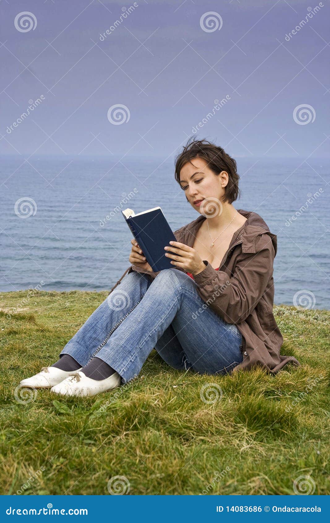 Woman reading by the sea stock photo. Image of beauty - 14083686