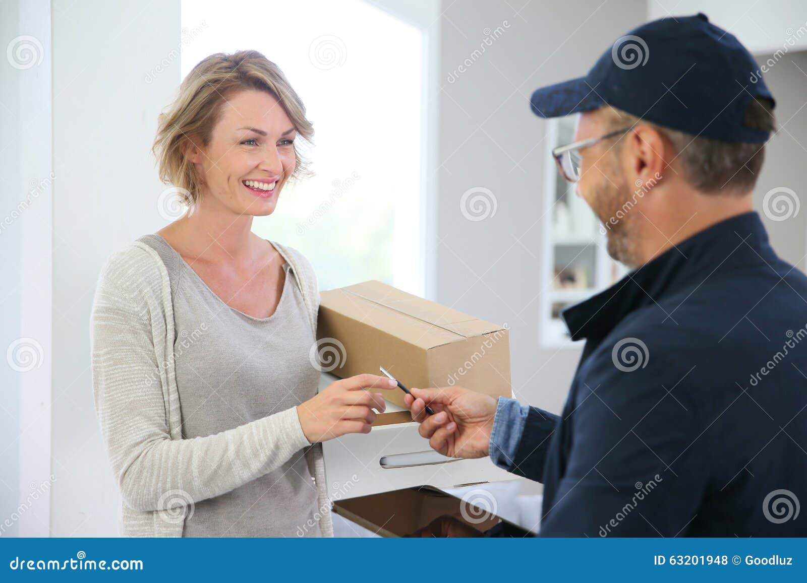 Woman Receiving Delivery Man with Package Stock Photo - Image of ...