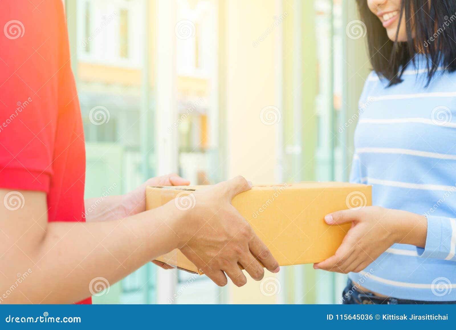 Woman Receiving Package from Delivery Man. Stock Photo - Image of ...