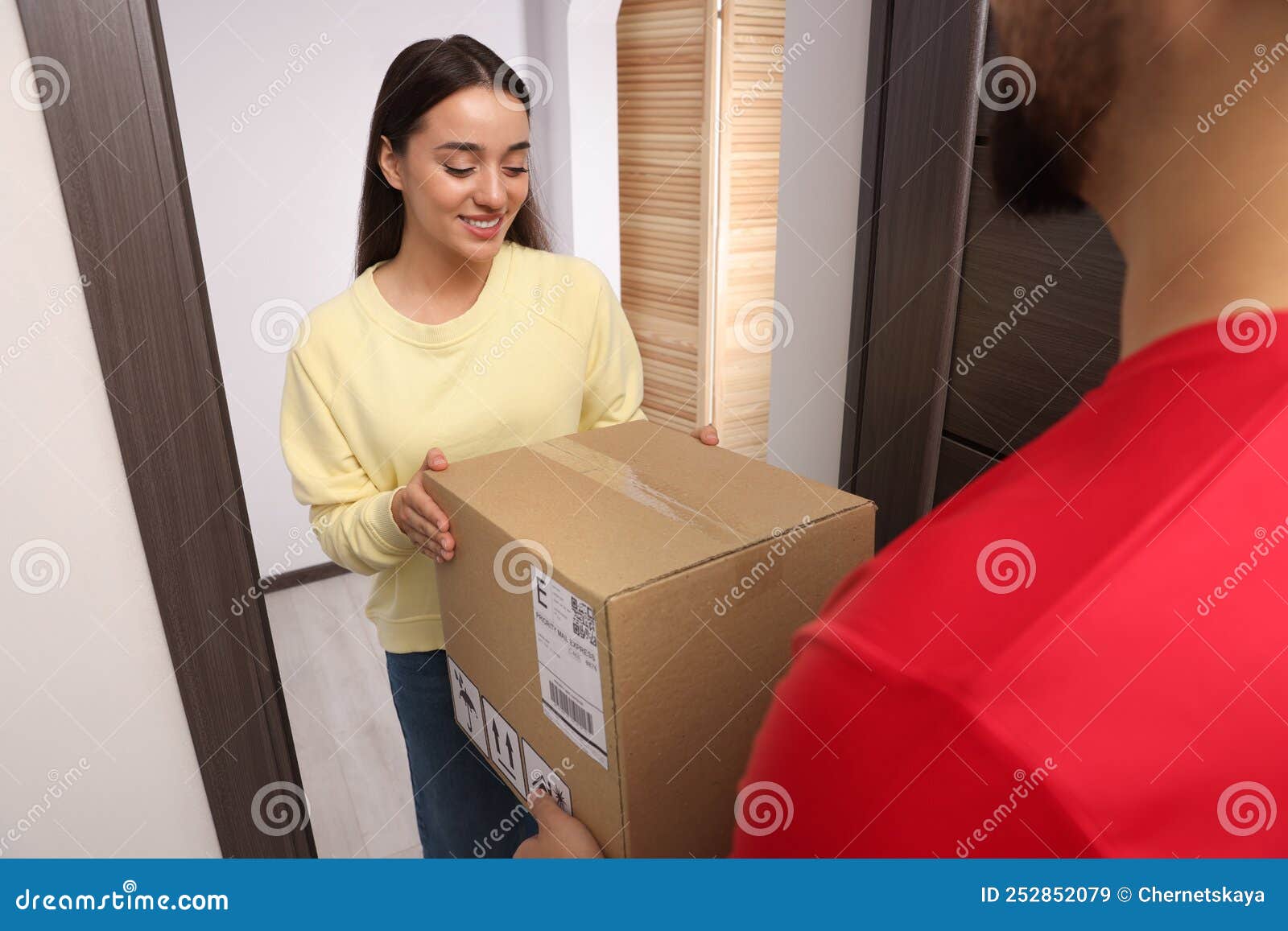 Woman Receiving Parcel from Courier at Home Stock Image - Image of ...