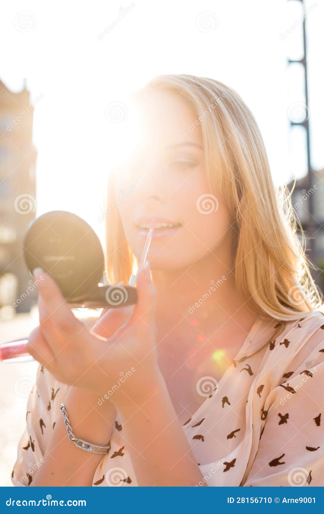 Woman Refreshing Makeup with Gloss in the Sun Stock Photo - Image of ...