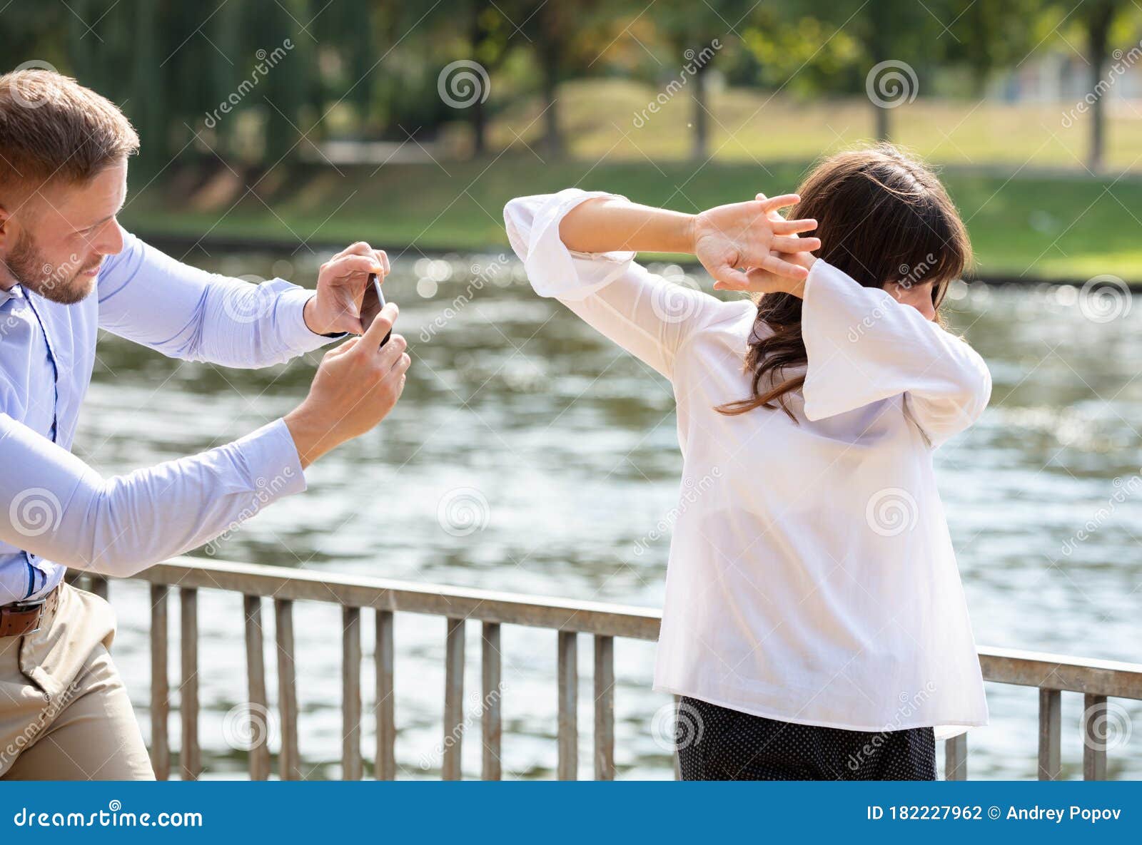 Woman Refusing Man Taking Her Photo on Mobile Phone Stock Photo - Image ...