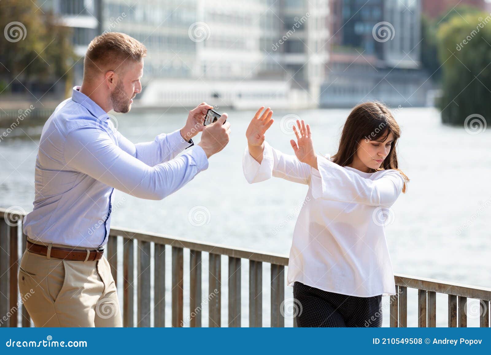 Woman Refusing Man Taking Her Photo on Mobile Phone Stock Photo - Image ...