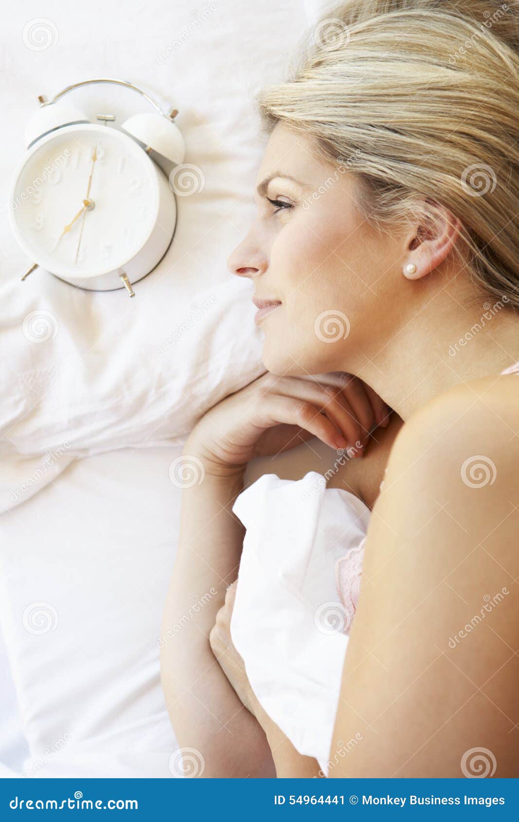 Woman Relaxing in Bed with Alarm Clock Stock Image - Image of caucasian ...