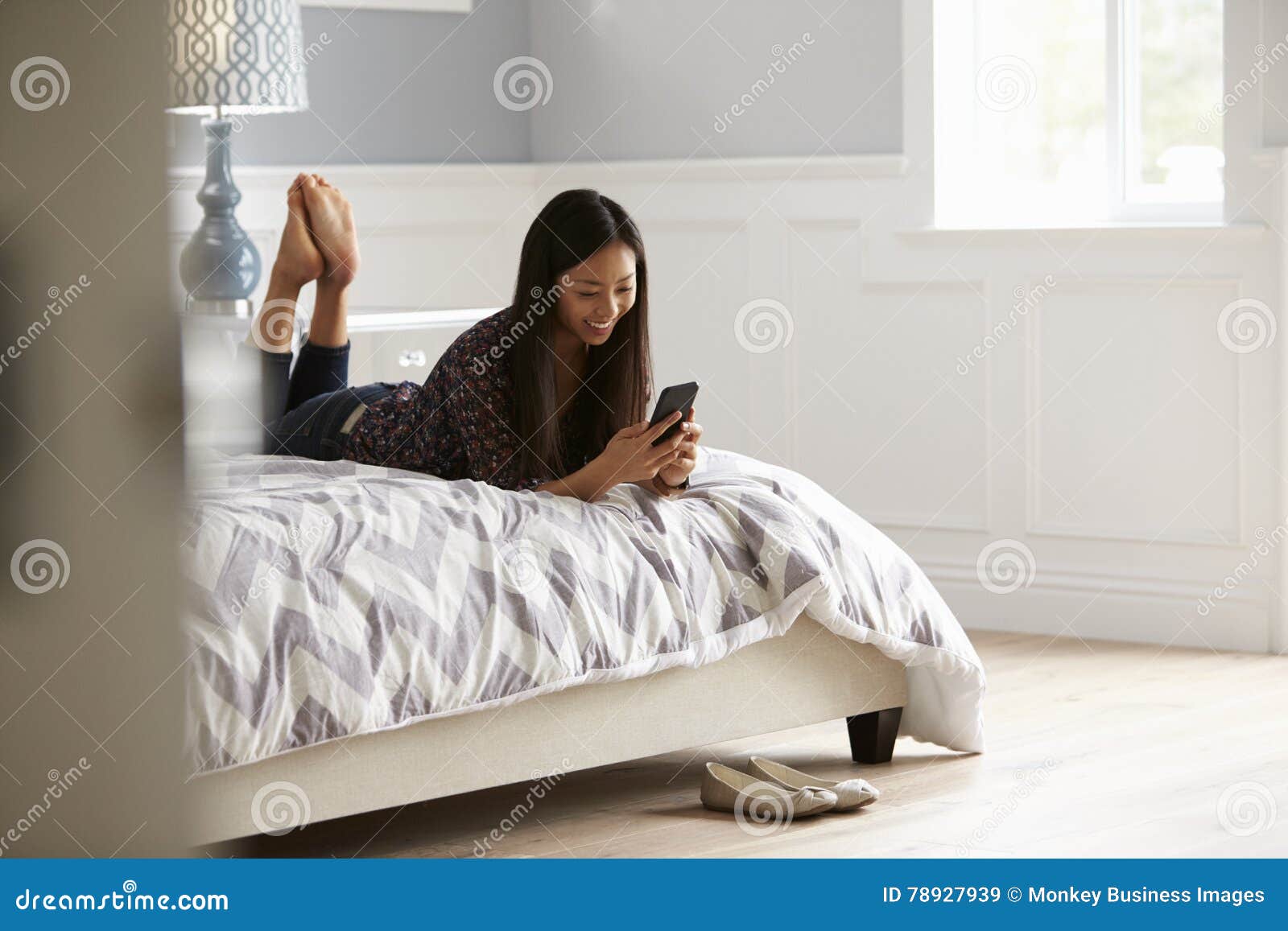 Woman Relaxing on Bed Checking Mobile Phone Stock Image - Image of ...