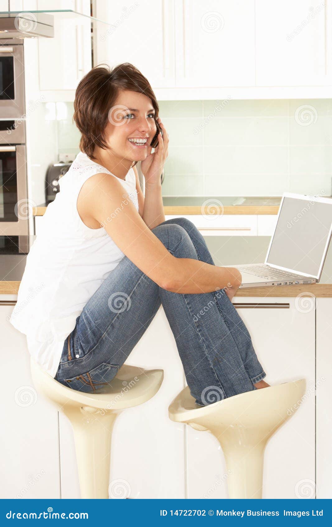 Woman Relaxing Sitting in Kitchen Talking on Phone Stock Photo - Image ...