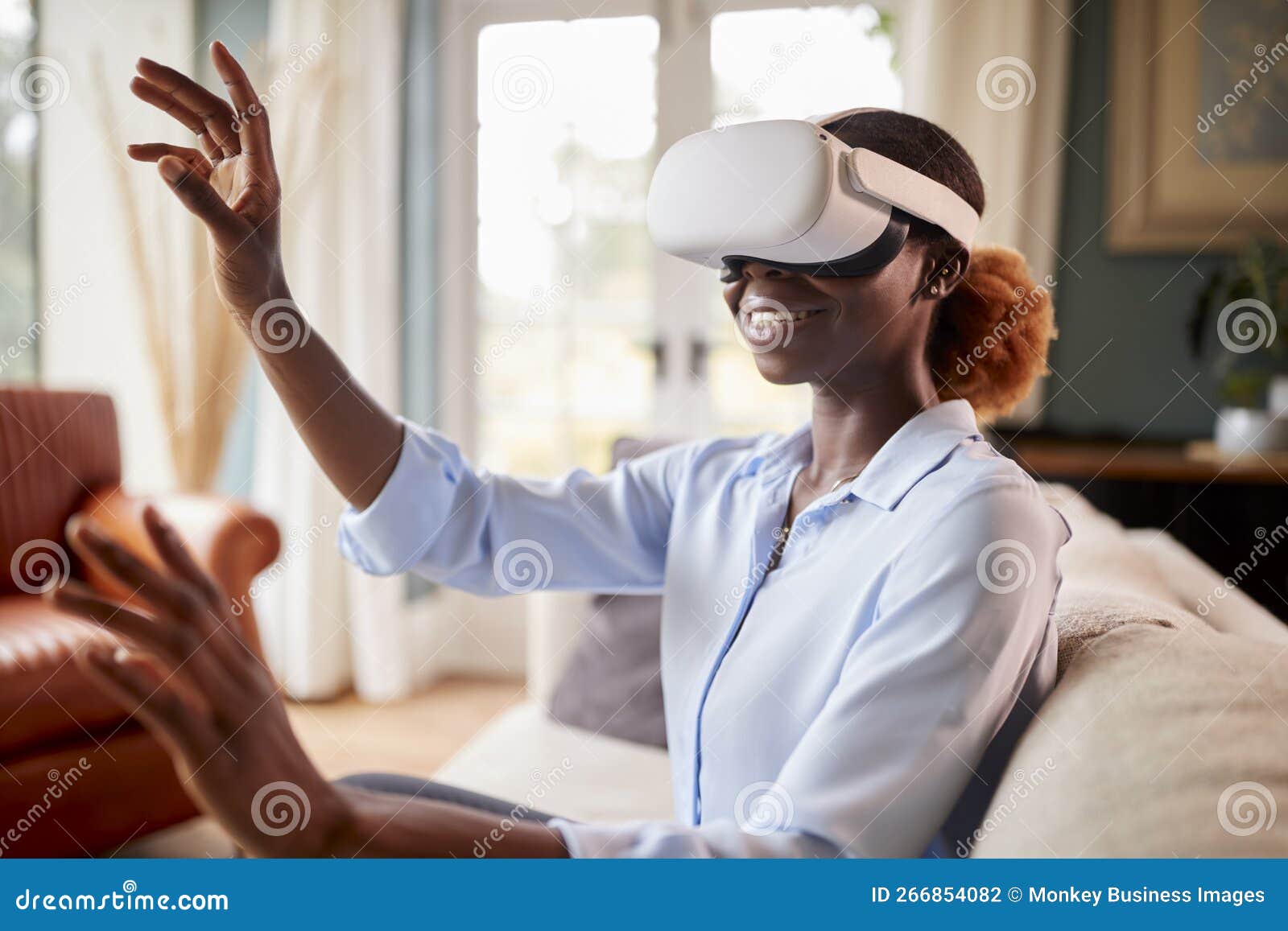 Woman Relaxing on Sofa at Home Wearing VR Headset and Interacting with ...