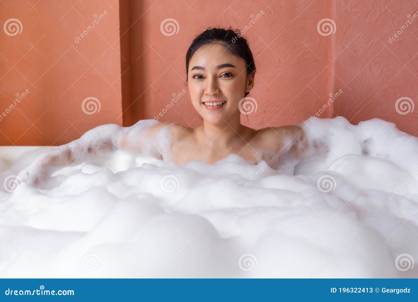 Woman Relaxing And Takes Bubble Bath In Bathtub With Foam Stock Image