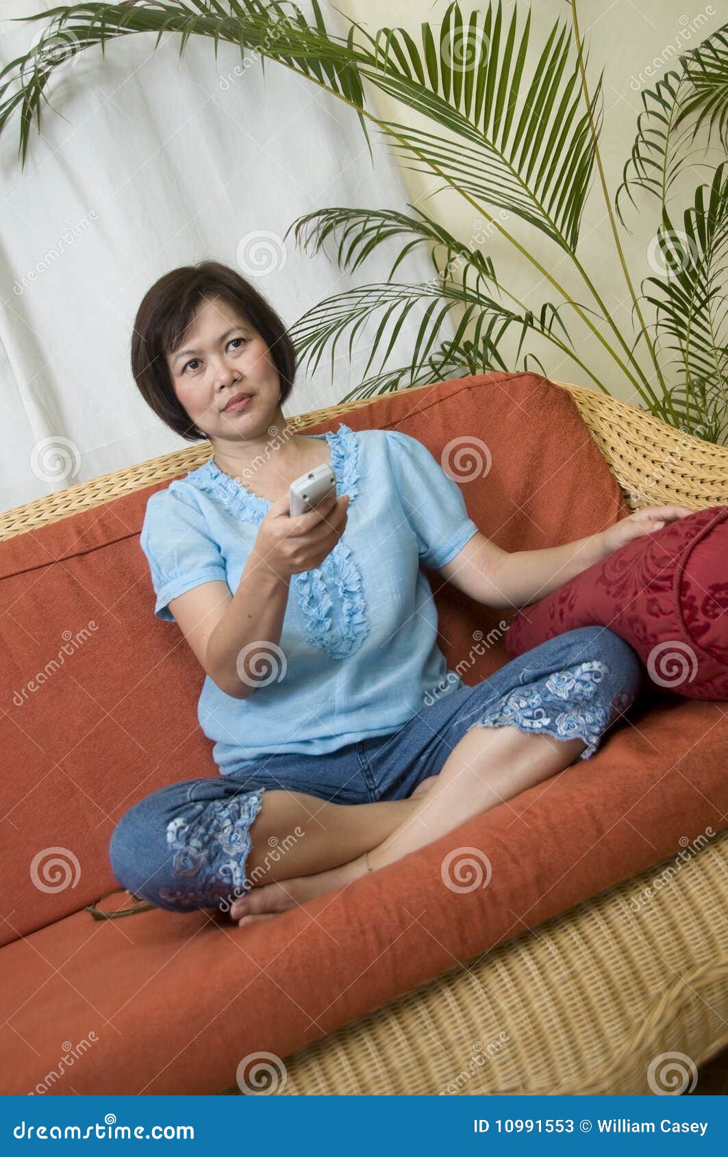 Woman with remote control stock image. Image of remote - 10991553