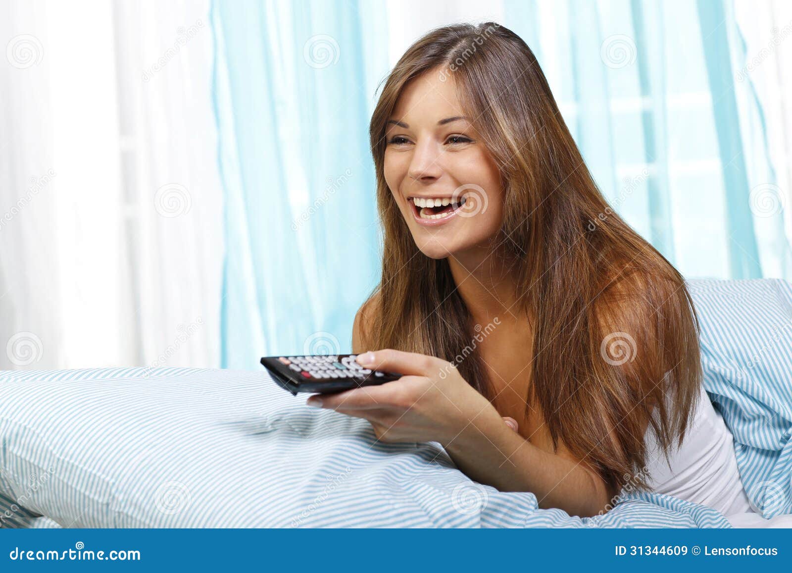 Woman with a Remote Control Stock Image - Image of control, look: 31344609