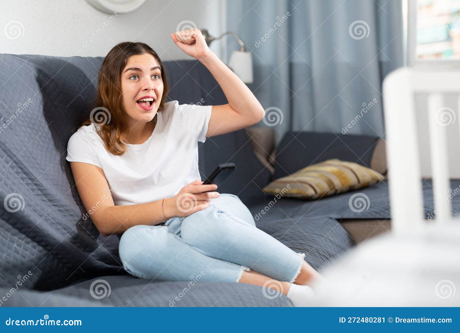 Woman with Remote Control Sitting on Sofa and Watching Tv Stock Image ...