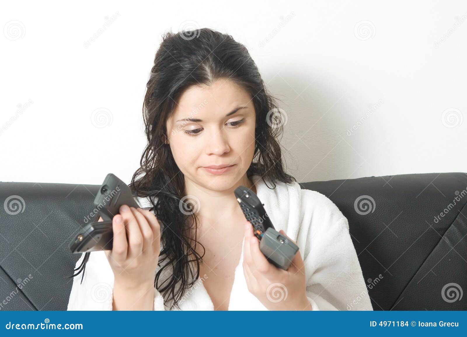 Woman with remote controls stock photo. Image of armchair - 4971184