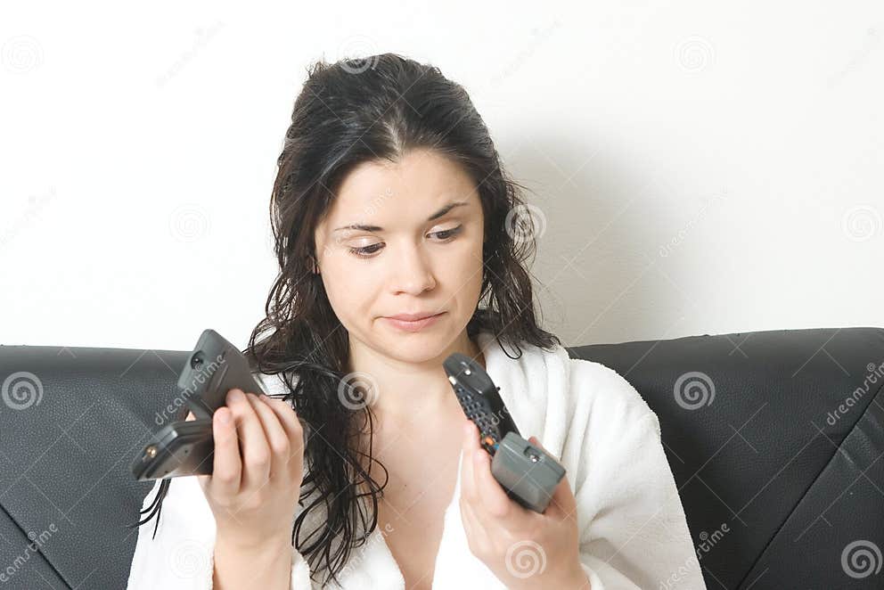 Woman with remote controls stock photo. Image of armchair - 4971184
