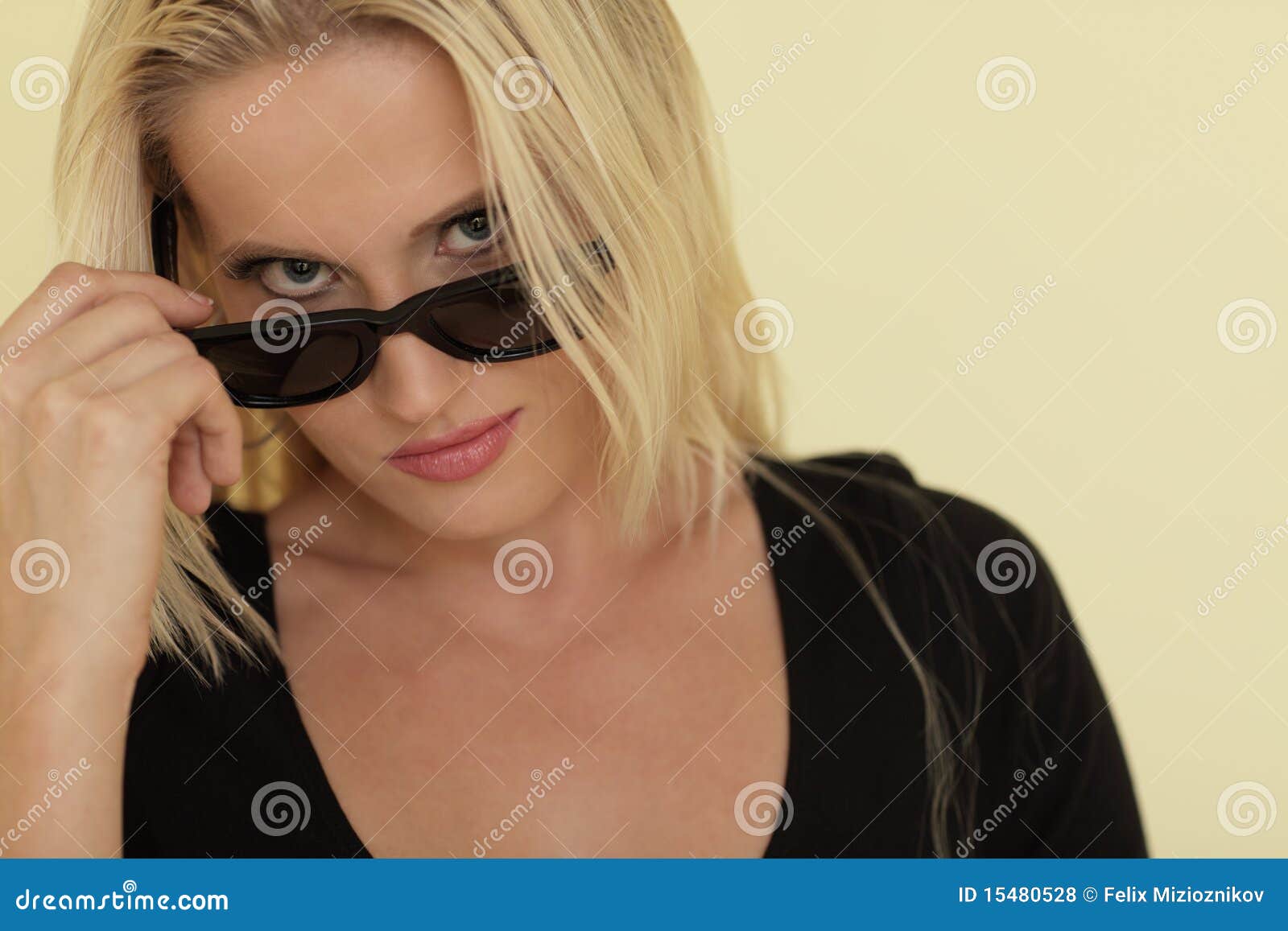 Woman Removing Her Sunglasses Stock Photo - Image of yellow, model ...