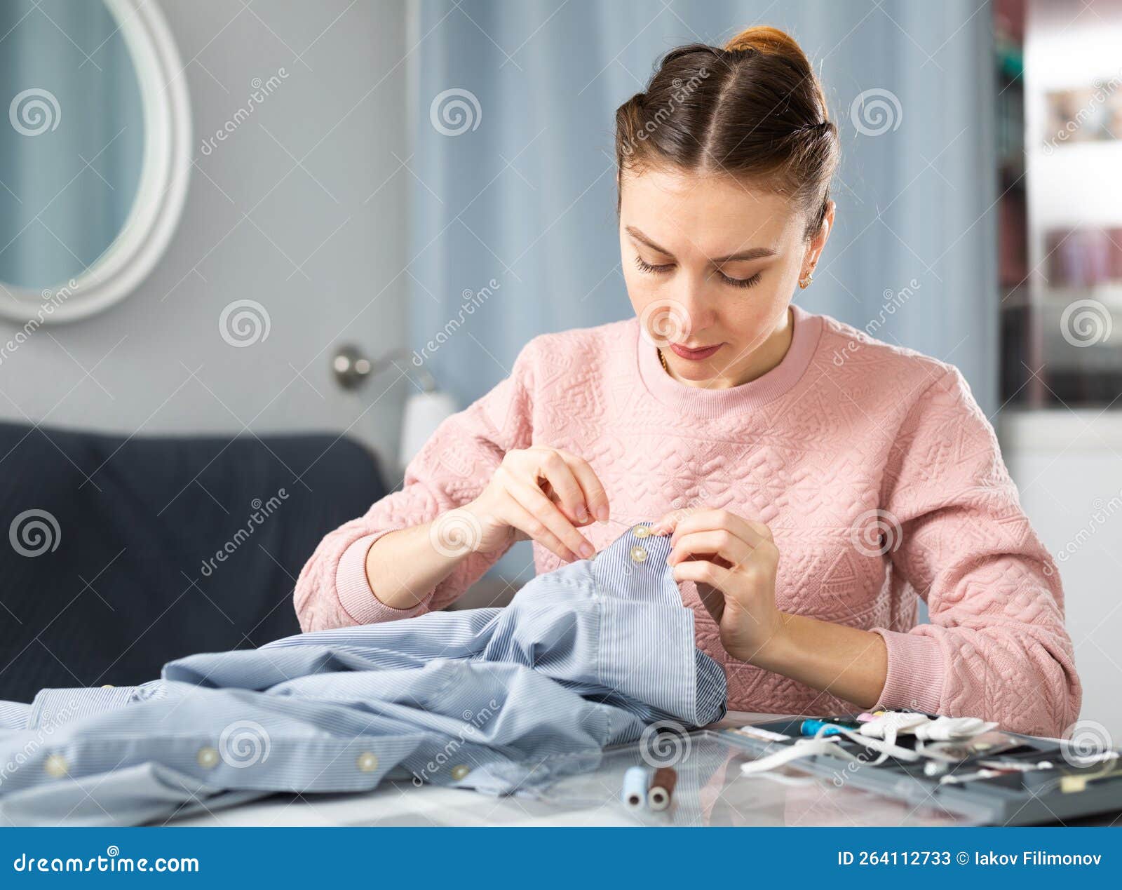 Woman Repairing Clothes with a Needle and Thread Stock Image - Image of ...