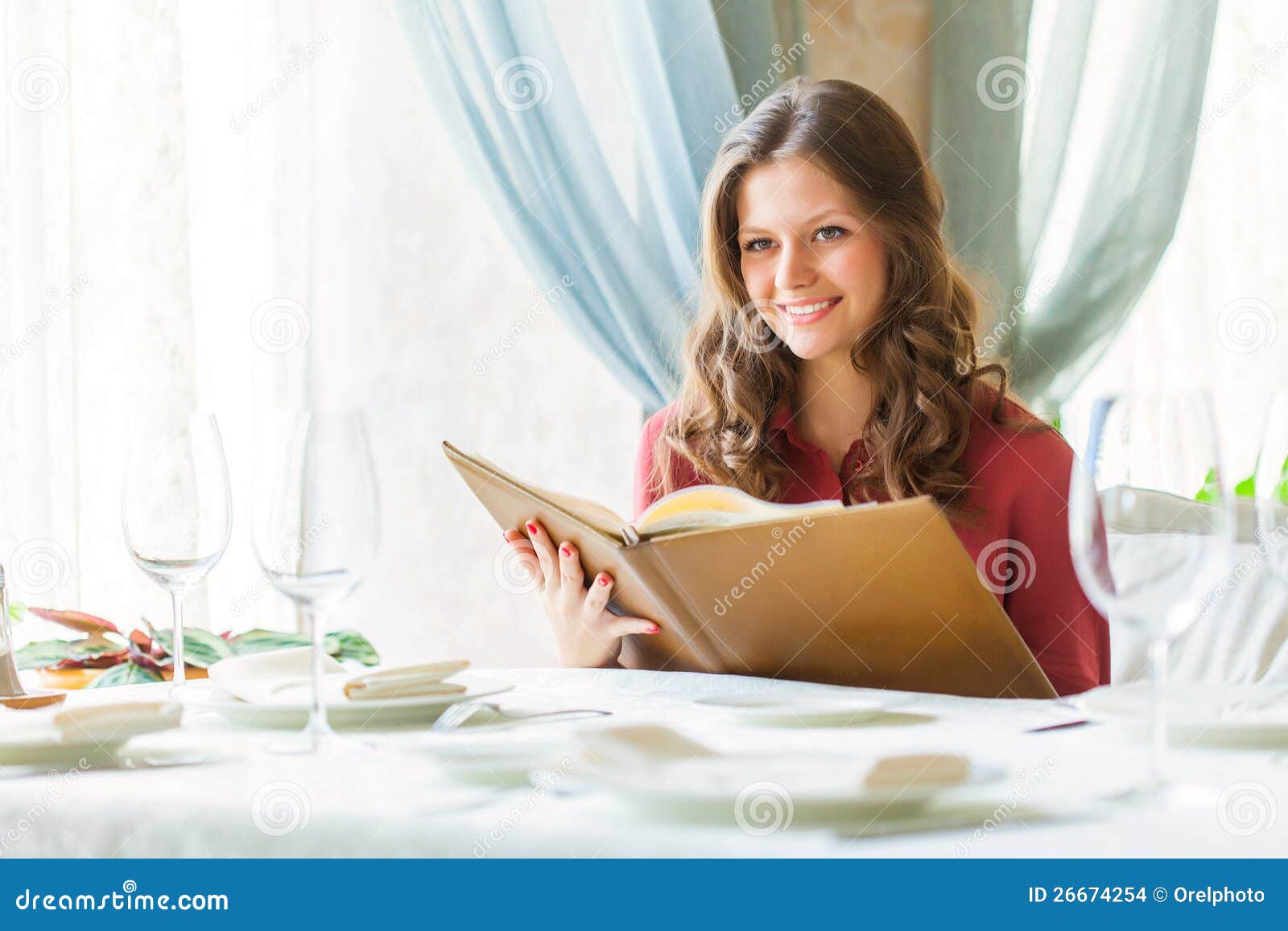 A Woman in a Restaurant with the Menu in Hands Stock Photo - Image of ...