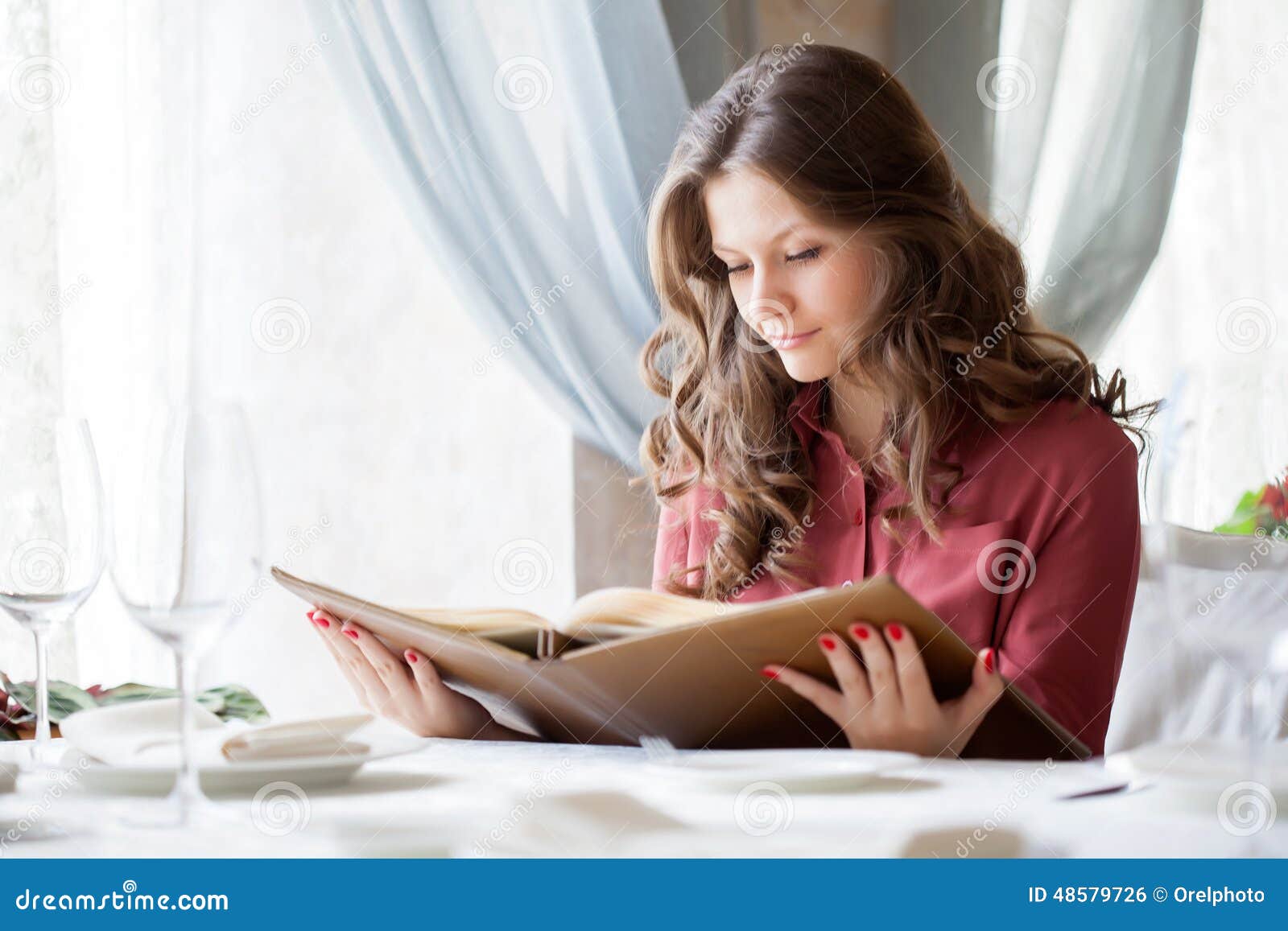 A Woman in a Restaurant with the Menu in Hands Stock Photo - Image of ...