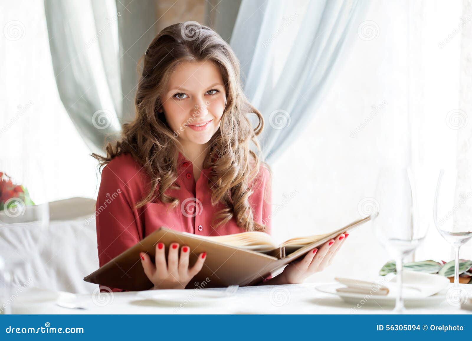 A Woman in a Restaurant with the Menu in Hands Stock Photo - Image of ...