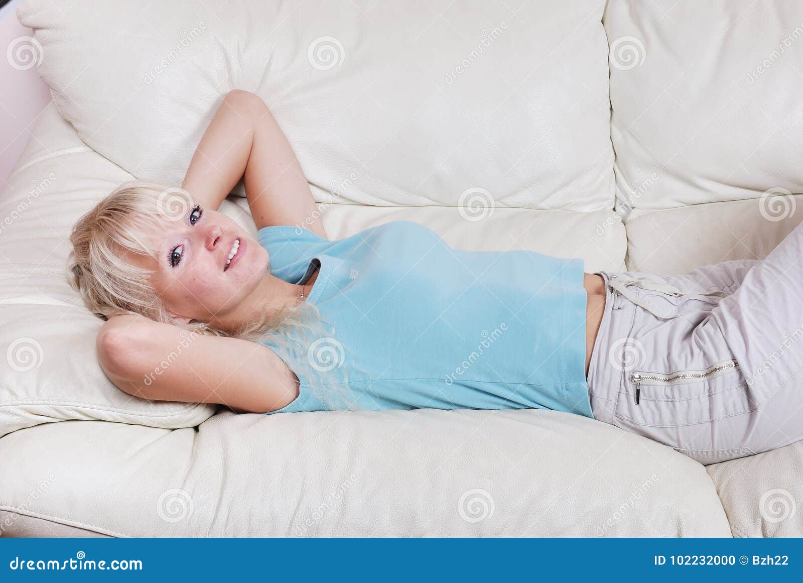 Woman resting on a sofa stock photo. Image of young - 102232000