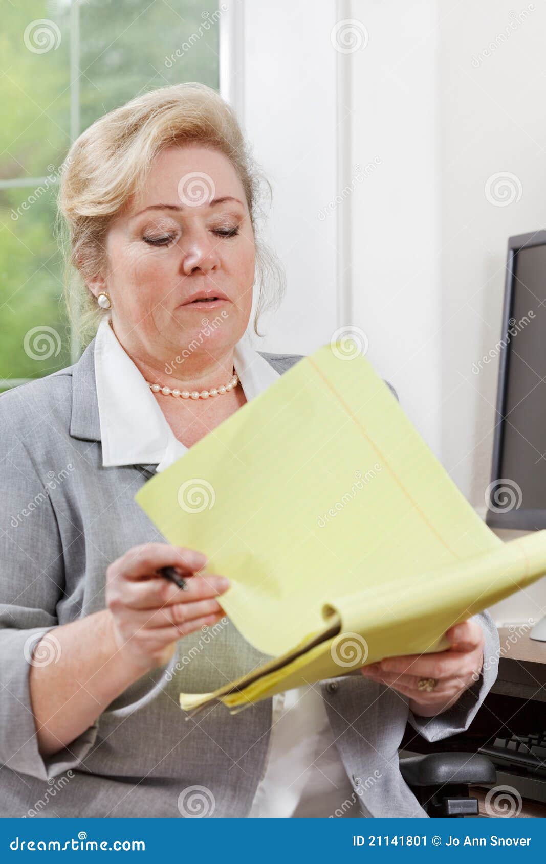 Woman reviewing notes stock image. Image of serious, paper - 21141801
