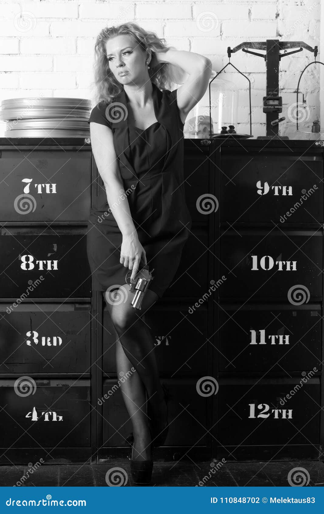 Woman with a revolver stock photo. Image of glamour - 110848702