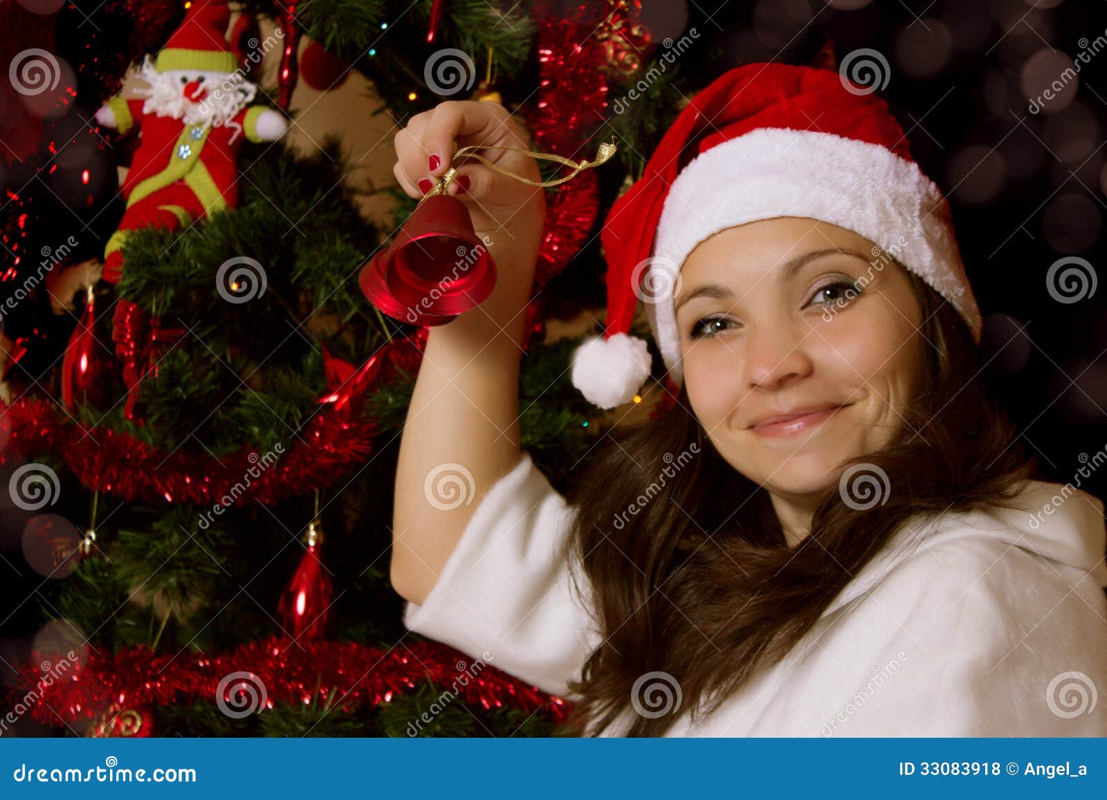 Woman Ringing the Bell Under Christmas Tree Stock Photo - Image of ...