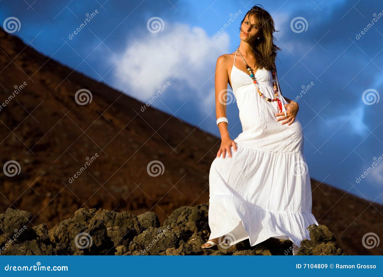 Woman on a rock stock image. Image of wind, arms, sunlight - 7104809