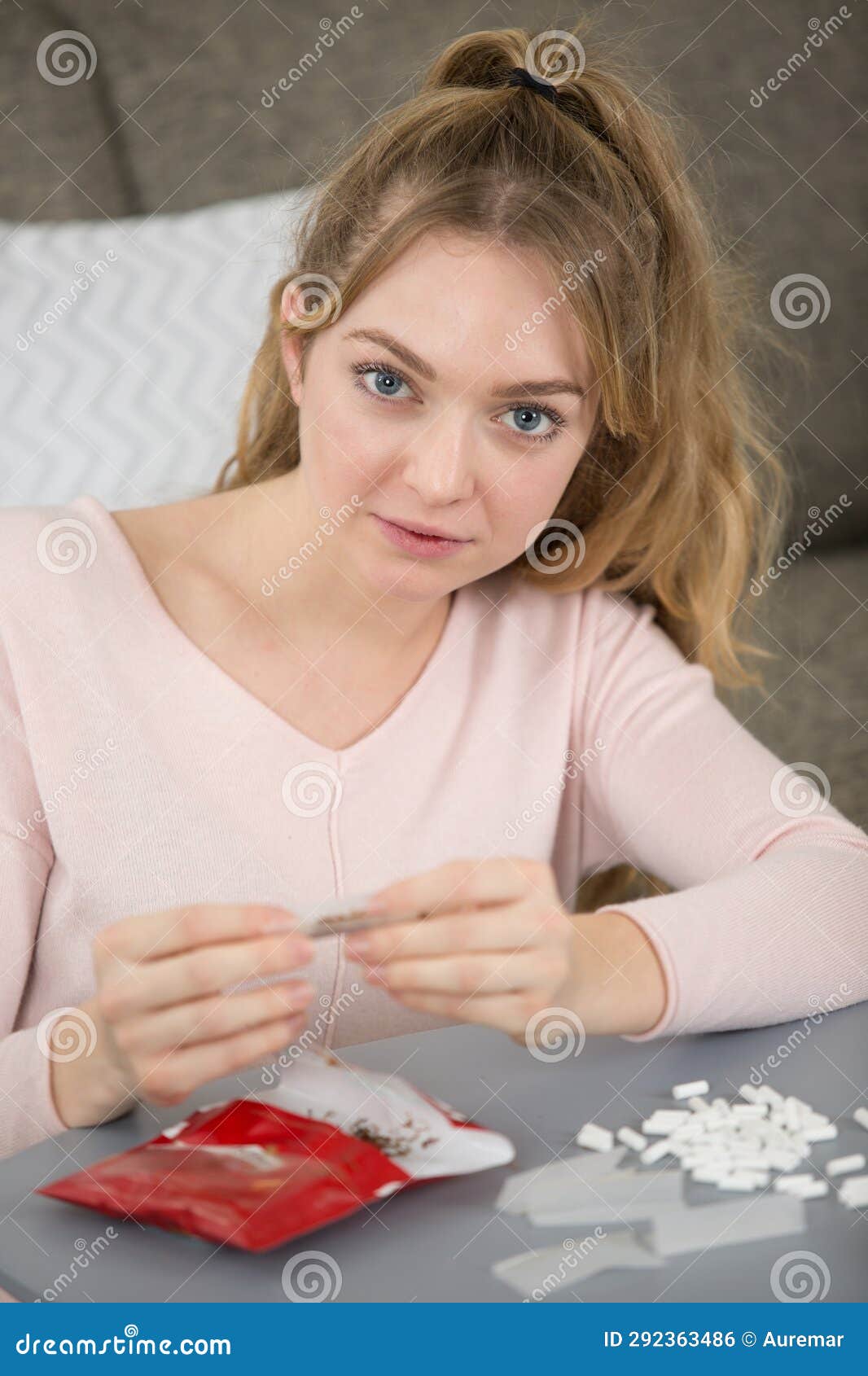 Woman Rolling Joint while Looking at Camera Stock Photo - Image of ...